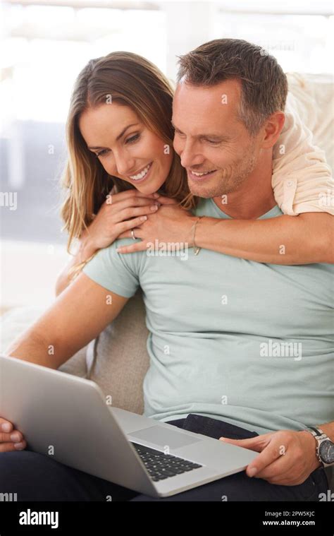 She Loves Watching Him Work A Married Couple Using Their Laptop At