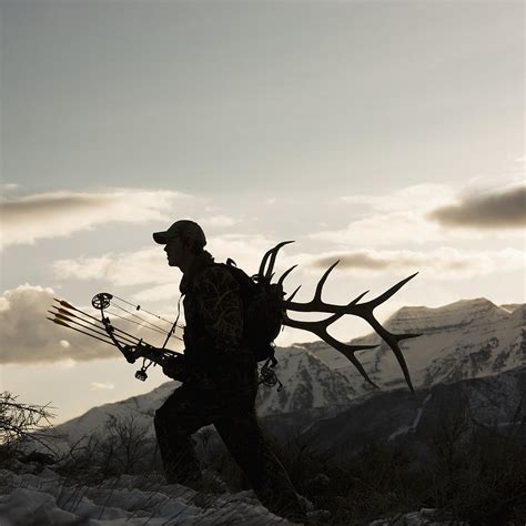 Silhouette Of Hunter Hiking With Elk Antlers Photograph
