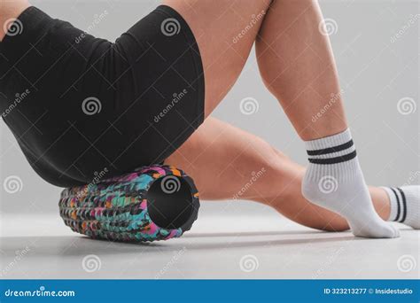 Faceless Woman Folds Bikini In A Suitcase On A Yellow Background The