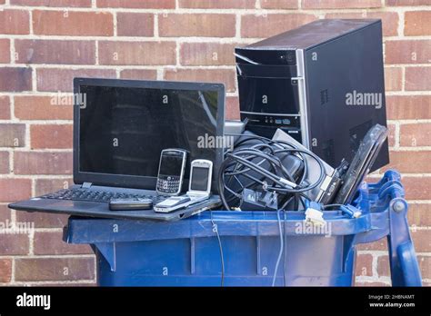 Old Computer Hardware And Mobile Devices Put Into A Recycling Container High Quality Photo