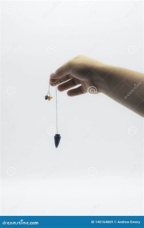 Pendulum Dowsing On An Isolated White Background With A Turquoise