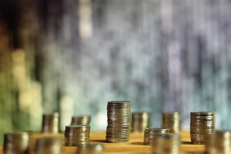 Premium Photo Stacked Coins Against Binary Code On Screen