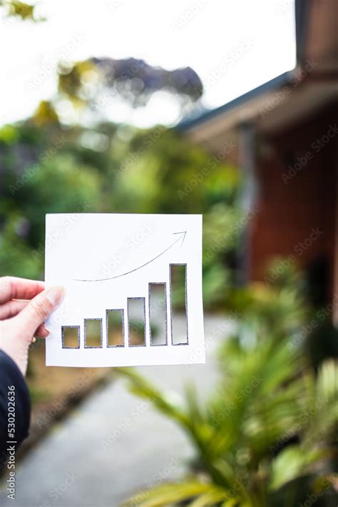 Property Value And Return On Investment Or Rent Price Hand Holding Real Estate Graph Showing