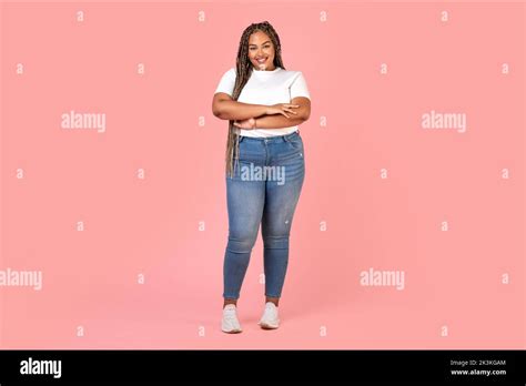 Attractive Black Plus Size Woman Model Standing Over Pink Background