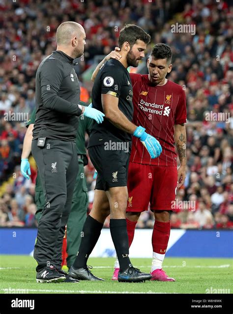 Liverpool Goalkeeper Alisson Centre Is Consoled By Team Mate Roberto