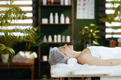 Relaxed Female In Massage Cabinet Laying On Massage Table Stock Image