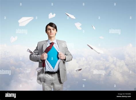 Young Businessman Acting Like Super Hero And Tearing His Shirt Off
