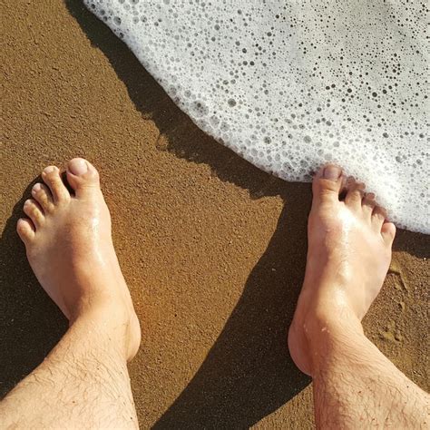 Premium Photo Close Up Of Bare Feet At Waters Edge