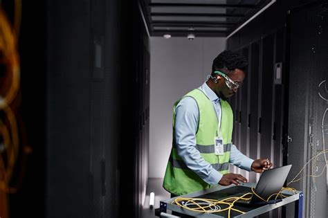 Premium Photo Young Network Technician Repairing Servers In Data Center