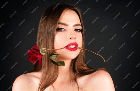 Premium Photo Seductive Sensual Woman Holding Red Rose With Teeth