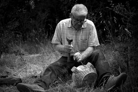 Premium Photo Senior Man Carving With Chisel And Hammer