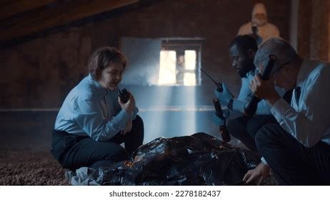 Diverse Team Police Officers Squatting Examining Stock Photo 2278182437