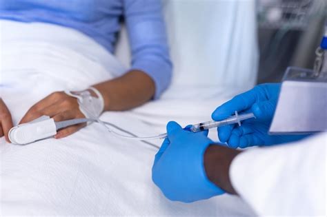 Premium Photo Midsection Of African American Male Doctor Giving Iv