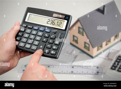 House Construction Concept Man Calculates The Cost Of Building A House