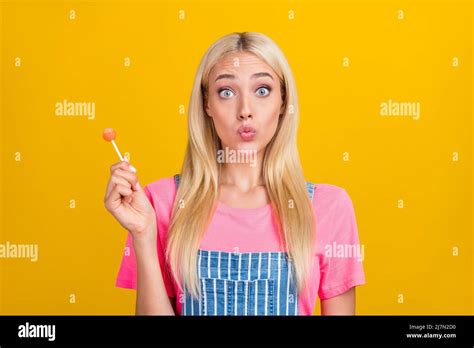 Portrait Of Attractive Funny Girly Teenage Girl Licking Candy Staring