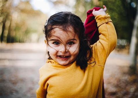 Premium Photo Portrait Of Smiling Girl Standing Outdoors