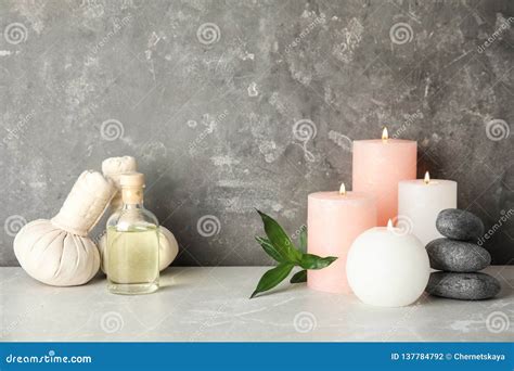 Spa Composition With Burning Candles And Essential Oil On Table Stock