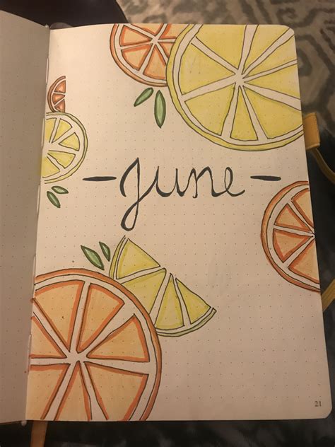 An Open Notebook With The Word June Written In Cursive Writing And Oranges