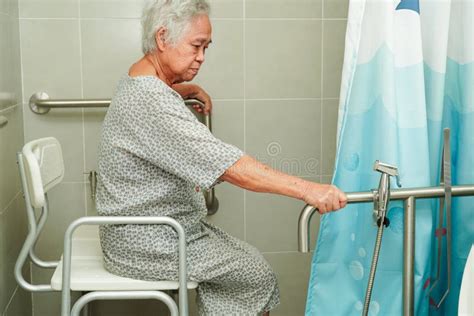 Asian Elderly Old Woman Patient Use Toilet Support Rail In Bathroom
