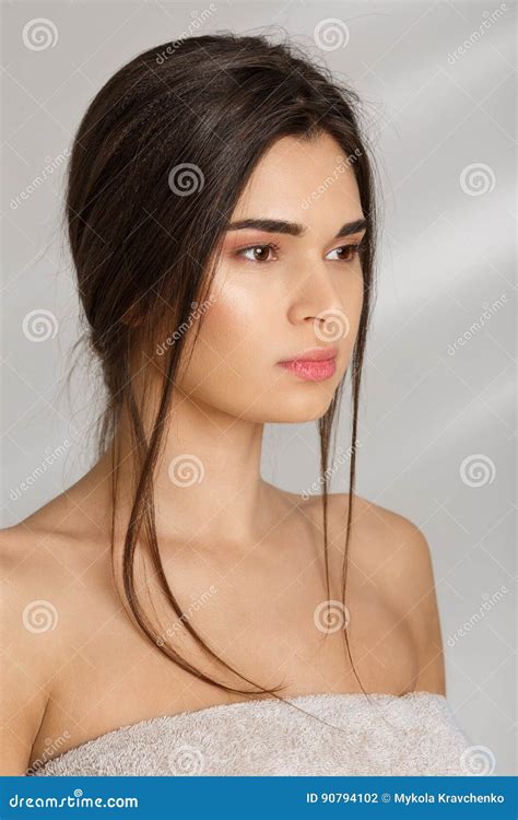 Portrait Of Woman Covering Herself With Towel Isolated On Grey Stock