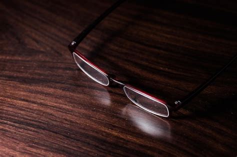 Premium Photo High Angle View Of Eyeglasses On Wooden Table