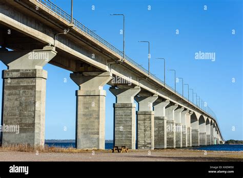 Empty Bench Under Concrete Bridge Gray Pillars Support The Weight Of