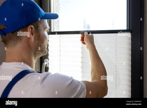 Worker Installing Pleated Blinds On The Window Stock Photo Alamy