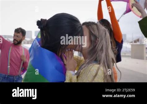 Two Young Loving Girls Kissing On Gay Pride Festival Day Outdoors