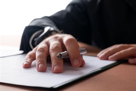 Premium Photo Businessman Holding A Pen Proofreading A Contract Or