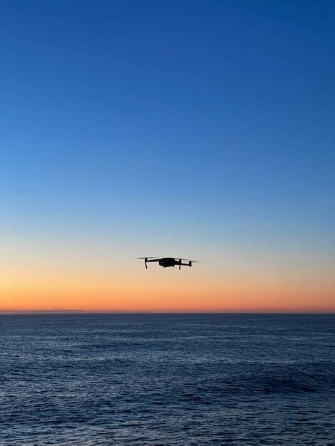 Premium Photo Drone Flying Over Sea During Sunrise