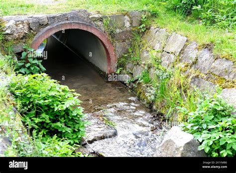 Close Up Concrete Semicircular Arch Of A Water Drain Well A Stream