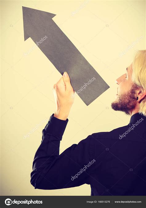 Man Holding Black Arrow Pointing Left Up Stock Photo By Anetlanda
