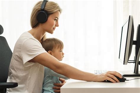 Premium Photo Young Freelancer Mother Working On Computer With Son Sitting On Her Lap
