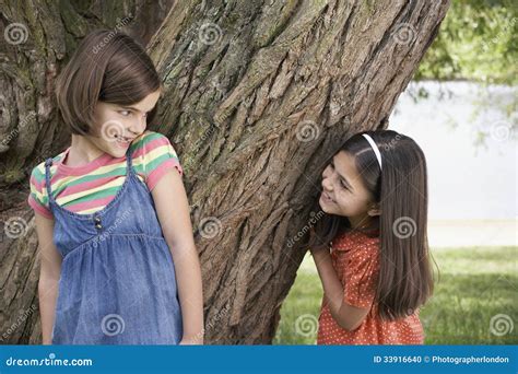 Girls Playing Hide And Seek By Tree Stock Photo Image Of Park Girl