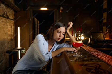 Premium Photo Lonely Sad Woman Sitting At Bar Touching Glass With