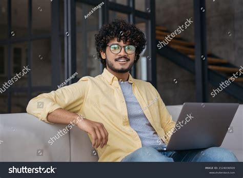 Handsome Confident Indian Programmer Using Laptop Stock Photo