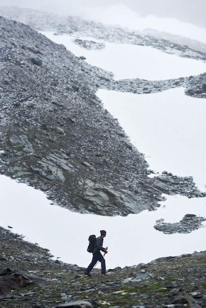 Premium Photo Male Hiker Walking On Rocky Path In Mountains