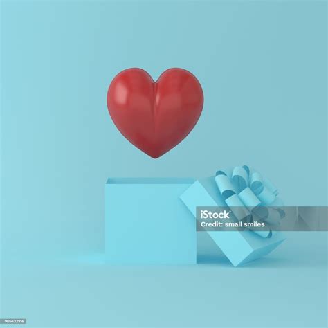 블루 파스텔 배경 선물 상자에 뛰어난 레드 심장 부동 사랑과 발렌타인의 아이디어 낭만적인 커플에 대 한 영원한 사랑 열정을