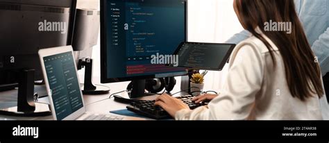 Software Development Team Working Together In Office Coding Script Display On Computer Monitor