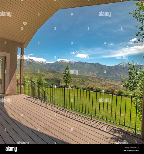 Square Home Balcony With Glass Access Door And Stairs That Leads To The