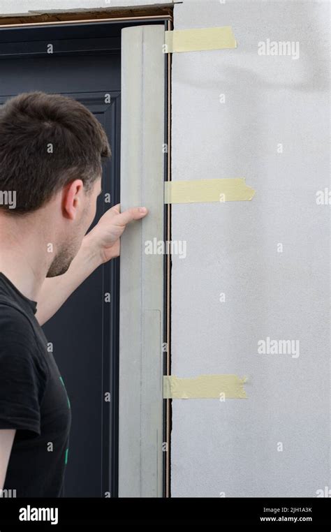 Checking The Door Frame For Evenness Of The Surface After Installation