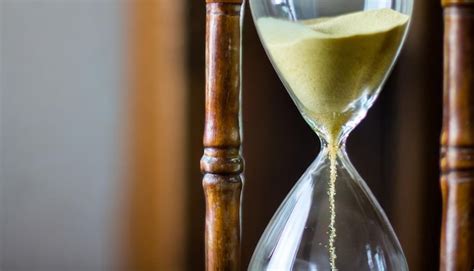 Premium Ai Image Elegant Hourglass With Flowing Sand Symbolizing