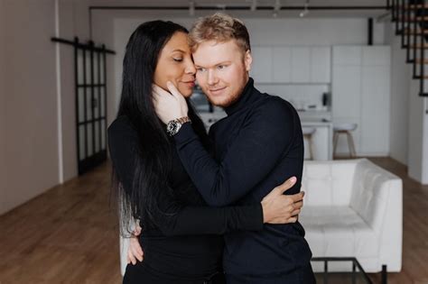 Premium Photo Young Husband Gently Hugs His Wife In The Kitchen