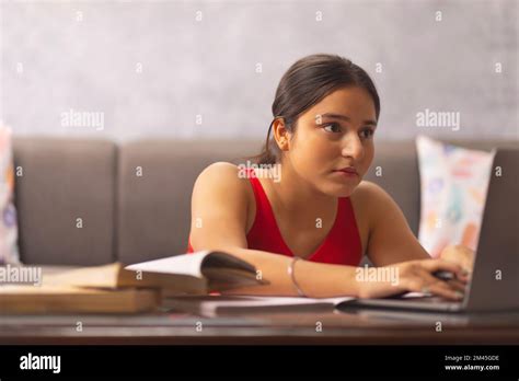 Portrait Of A Teenage Girl Doing Homework During Online Classes Stock