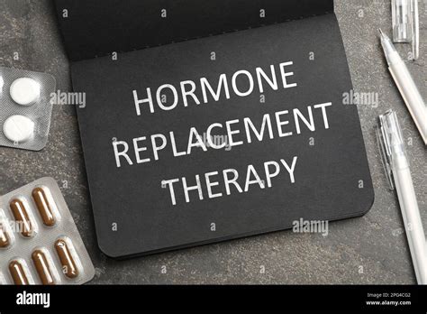 Black Notebook With Text Hormone Replacement Therapy Pills And Pens On