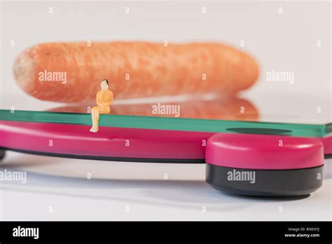 Miniature Woman Figure Siting On The Digital Electronic Bathroom Scale For Weight Of Human Body