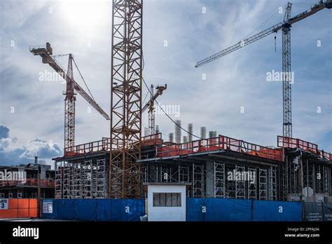 Industrial Landscape With Silhouettes Of Constraction Cranes On
