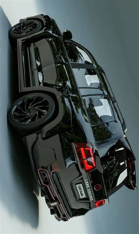 The Back End Of A Black Car With Its Hood Up And Wheels Down Against A