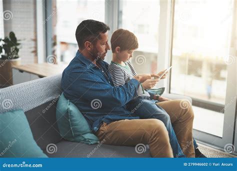 Youre Getting Good A Cheerful Little Boy Browsing On A Digital Tablet