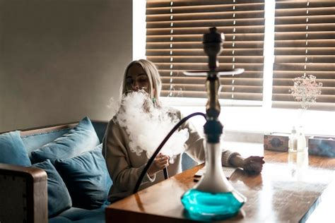 Premium Photo A Young Girl Chilling In The Lounge And Smoking The Hookah